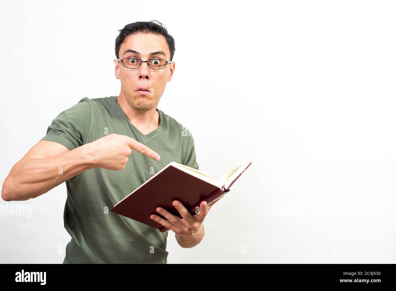 Man reading something that is surprising him a lot in a book. Mid shot ...