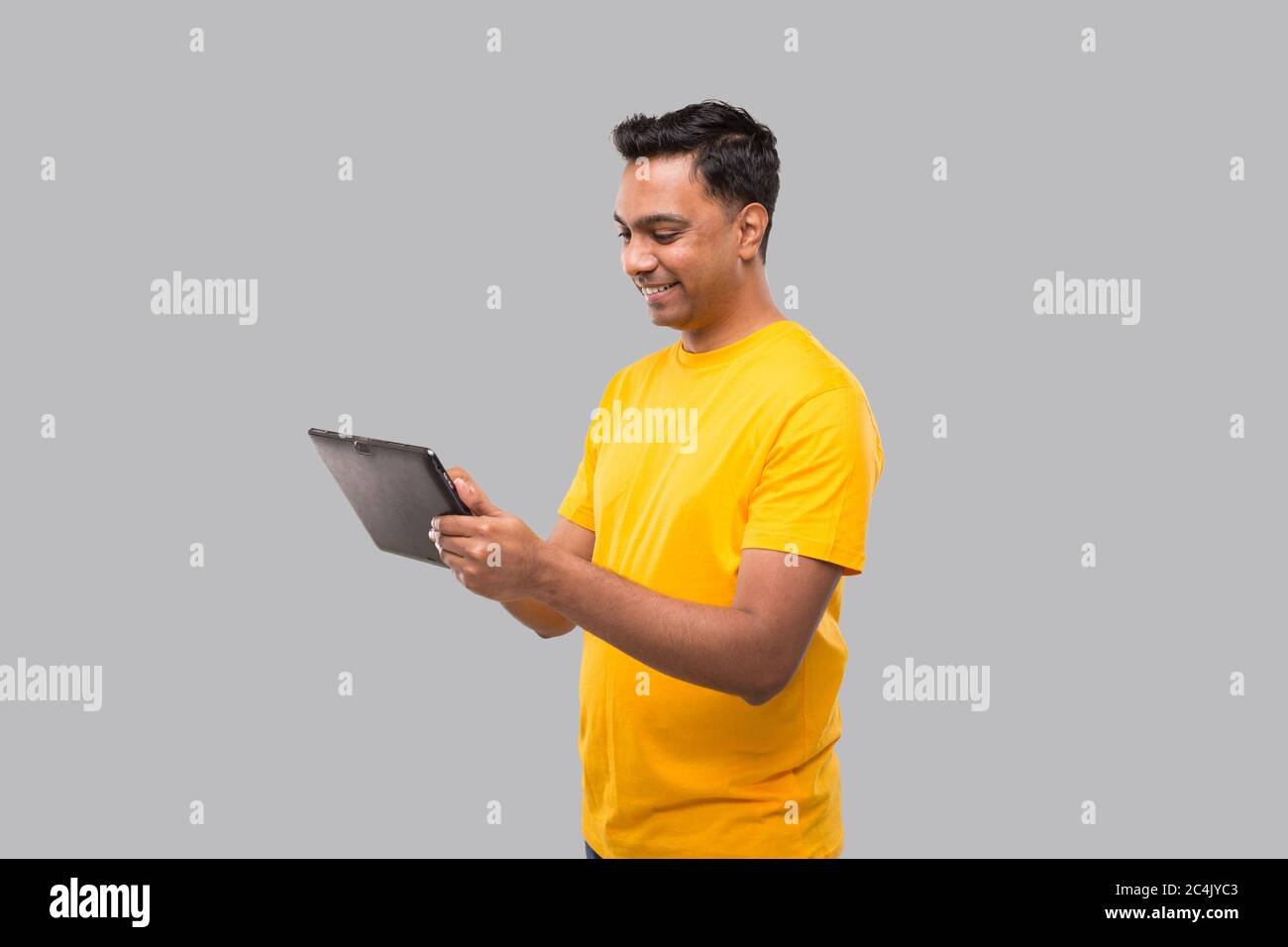Indian Man Using Tablet. Indian Boy with tablet in Hands. Home Delivery ...