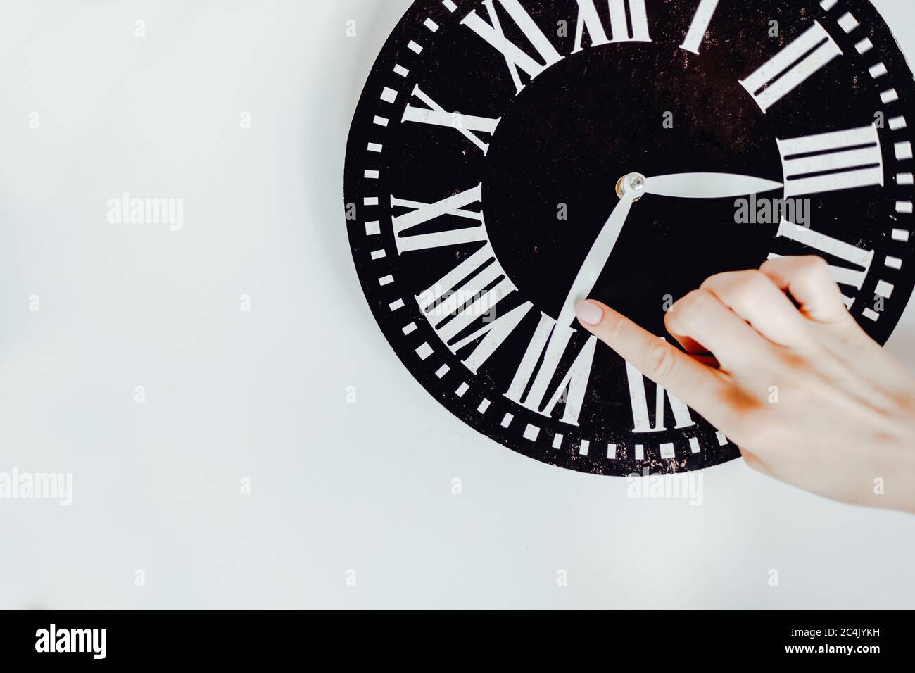 Hand translates an arrow on the clock Stock Photo - Alamy