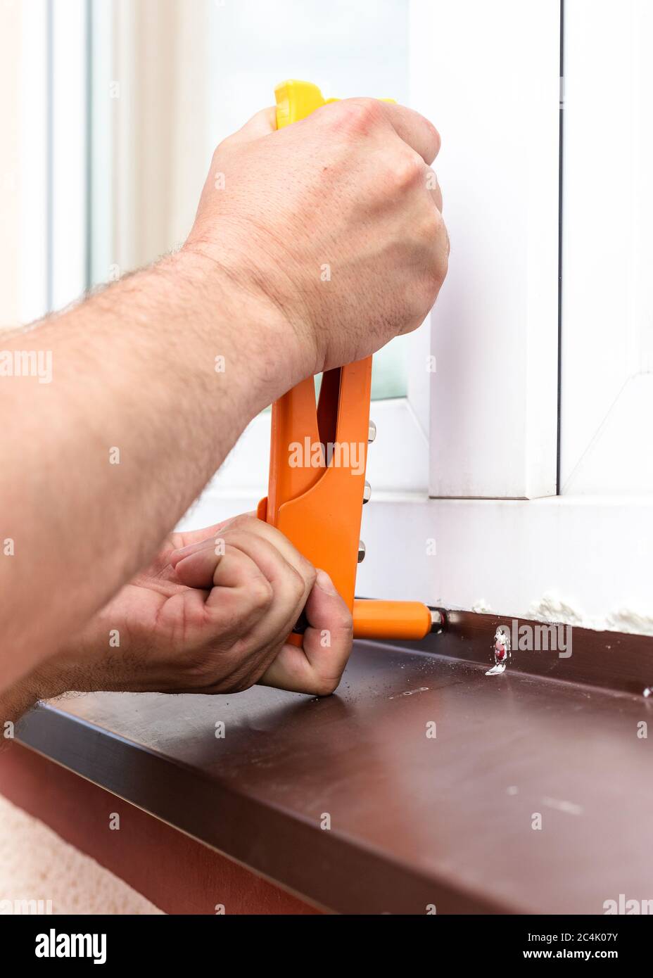 Construction work - installation of rivets. Window tint repair. Plastic ...