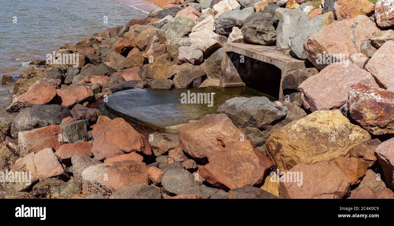 Close up of a drainage culvert letting water storm water escape out to ...