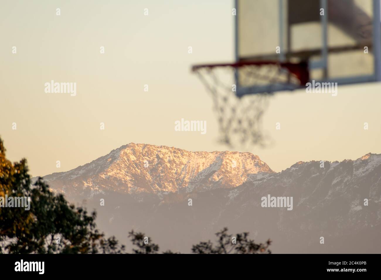 A basketball hoop with the mountain range in the background; Chail ...