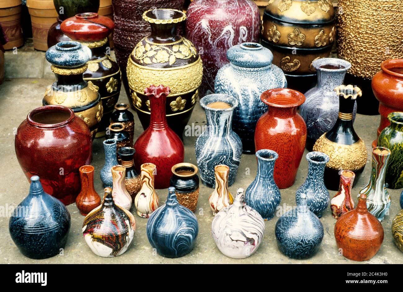 Colourful earthenware like pots, jars and vases enhance the beauty of ...
