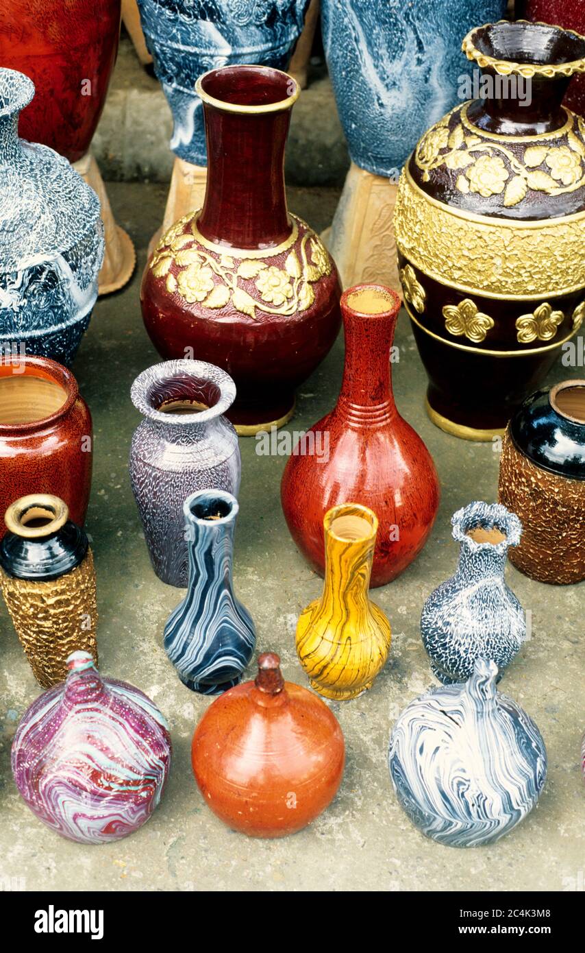Colourful earthenware like pots, jars and vases enhance the beauty of ...