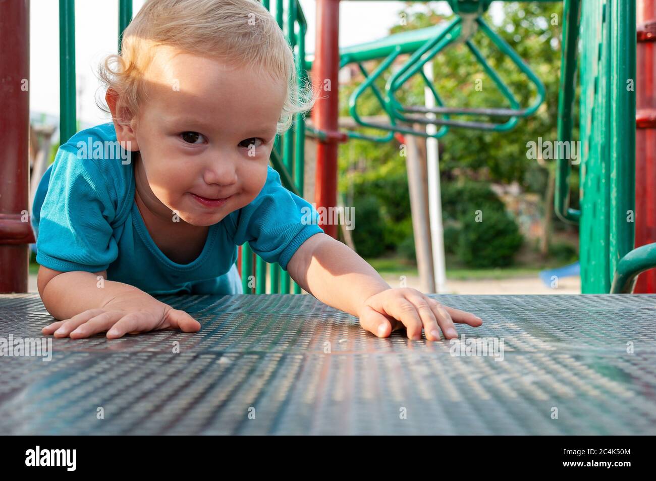Child playing at a playground and making funny faces Stock Photo - Alamy