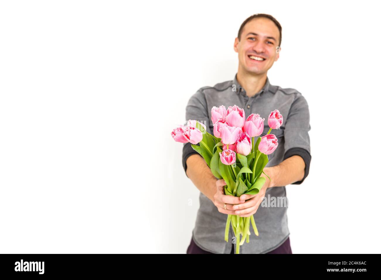 Man with flowers. Romantic Man with bouquet of tulips for birthday ...