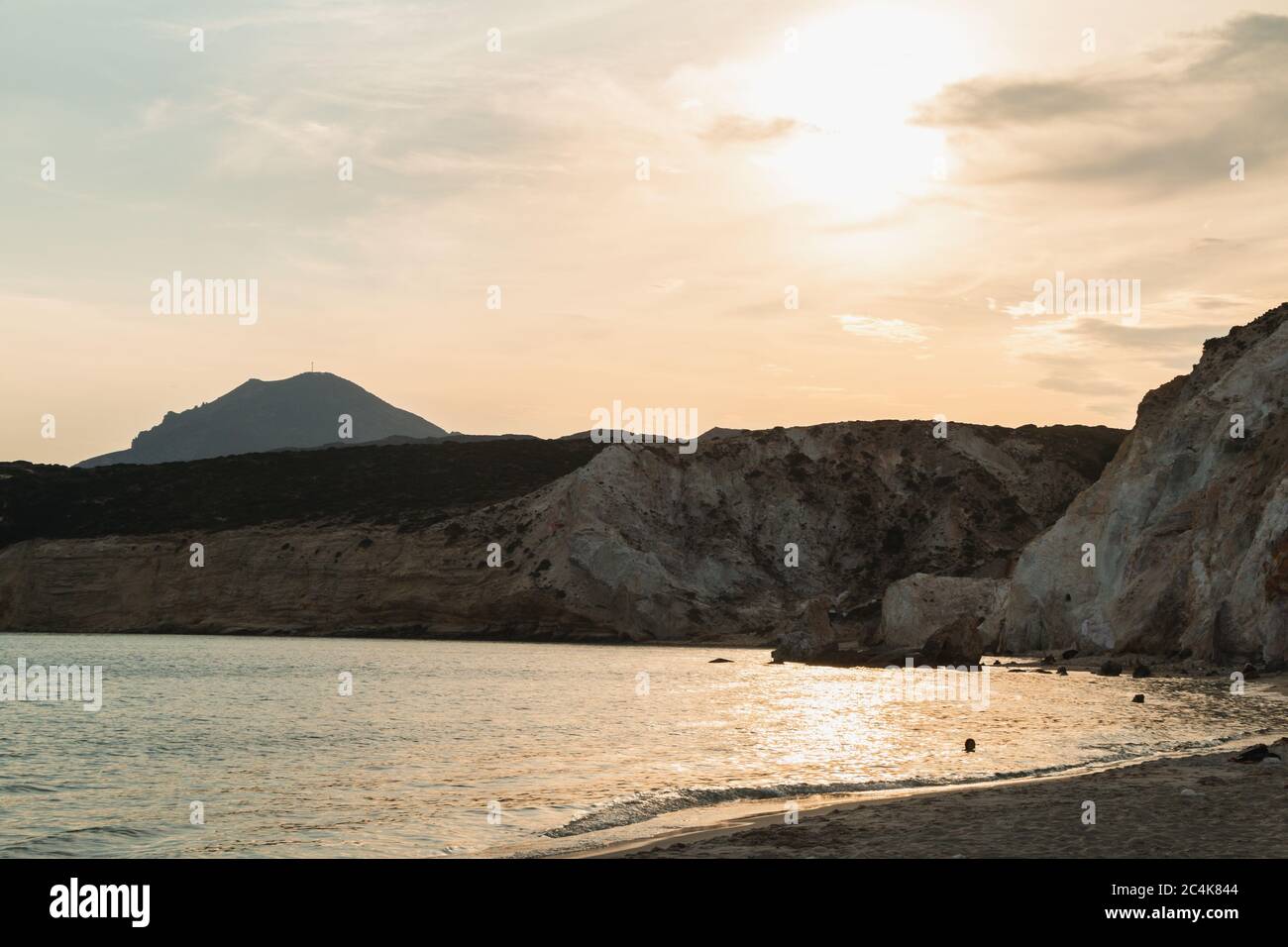 A dramatic sunset over Firiplaka Beach in Milos, Greece Stock Photo - Alamy