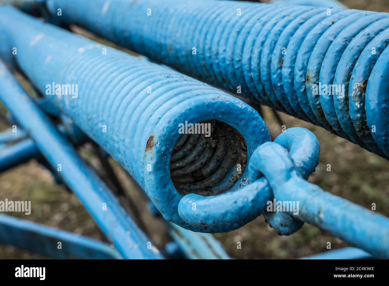 spring mechanism on an old agricultural machine Stock Photo - Alamy