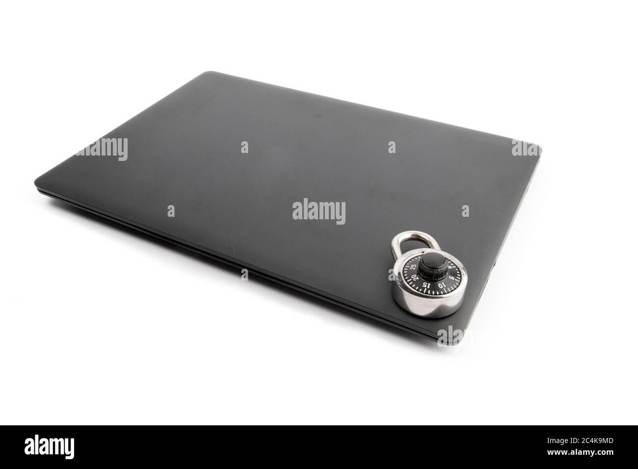 a closed notebook computer with a combination lock on it isolated on ...