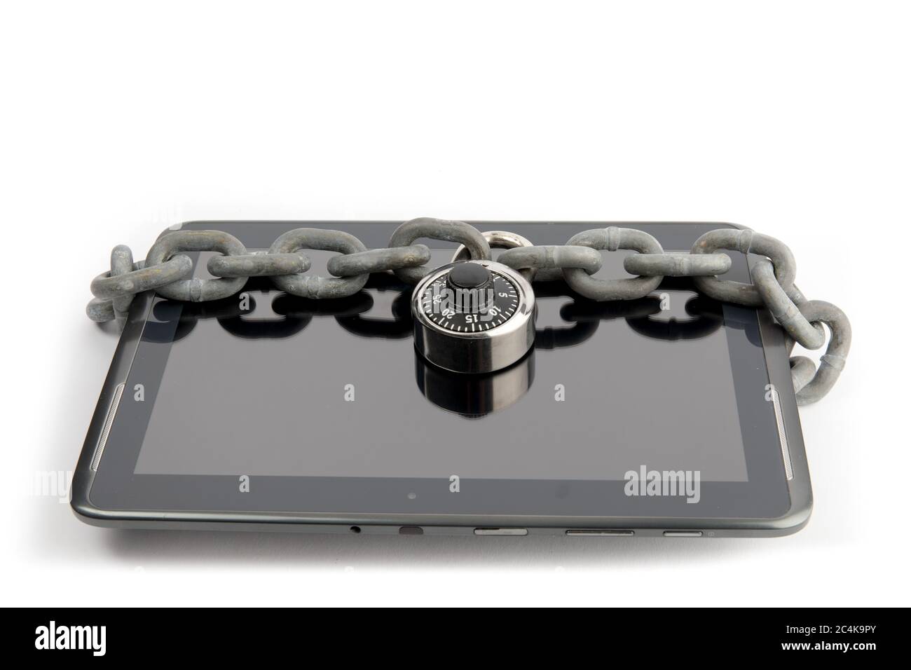 a tablet computer pad with a chain and lock wrapped around it isolated ...