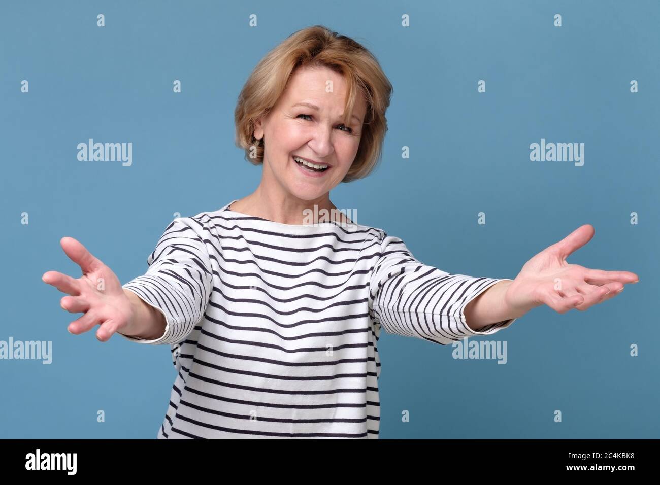 woman raised up palms arms hands at you, welcoming her friends Stock ...