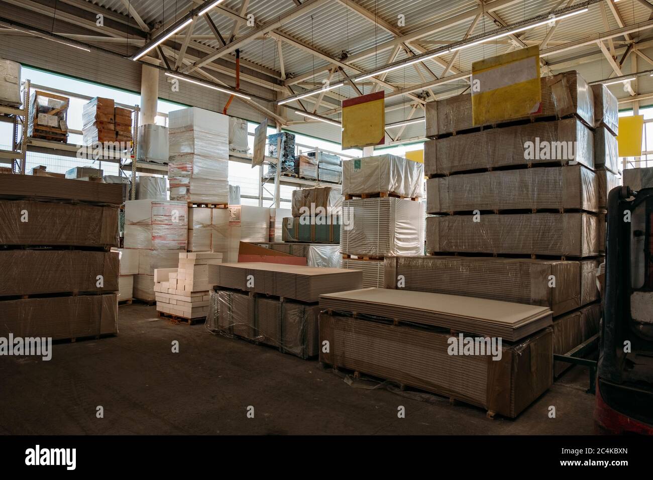 Stack of construction materials in the warehouse Stock Photo - Alamy