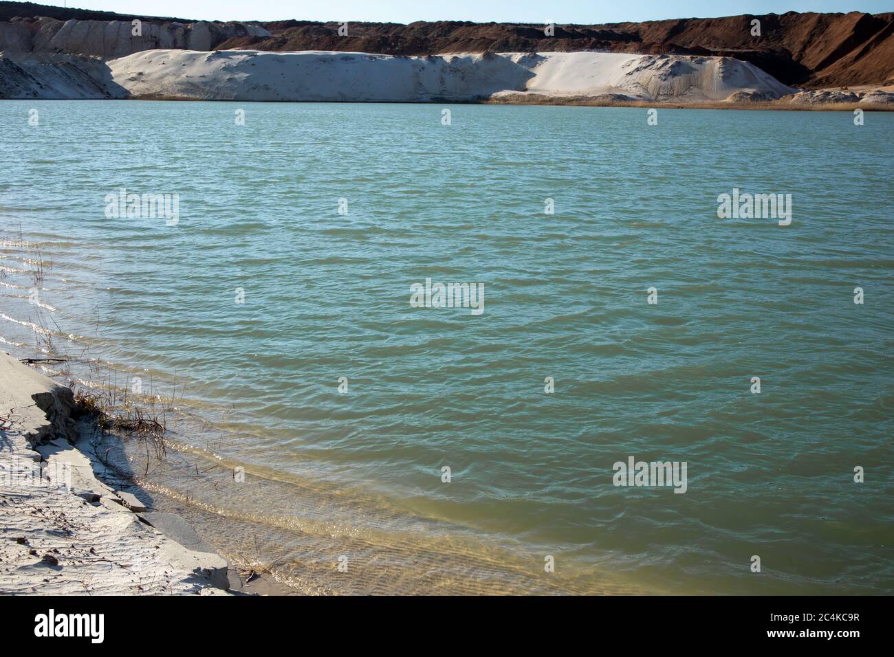 Pond in the desert. White sand mountains and blue water and sky Stock ...