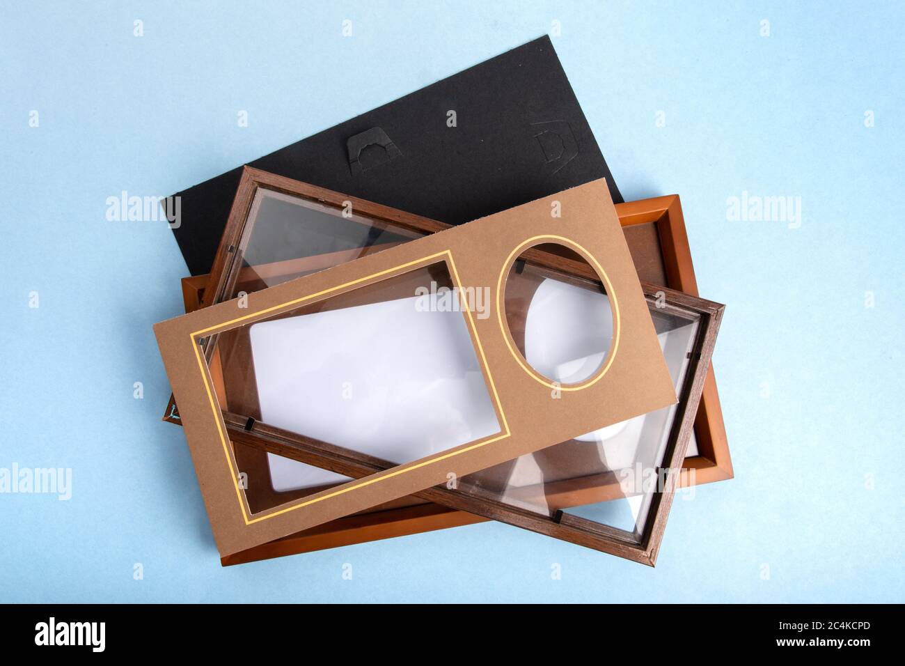 top down view of an empty wooden photo frame and mat with another frame ...