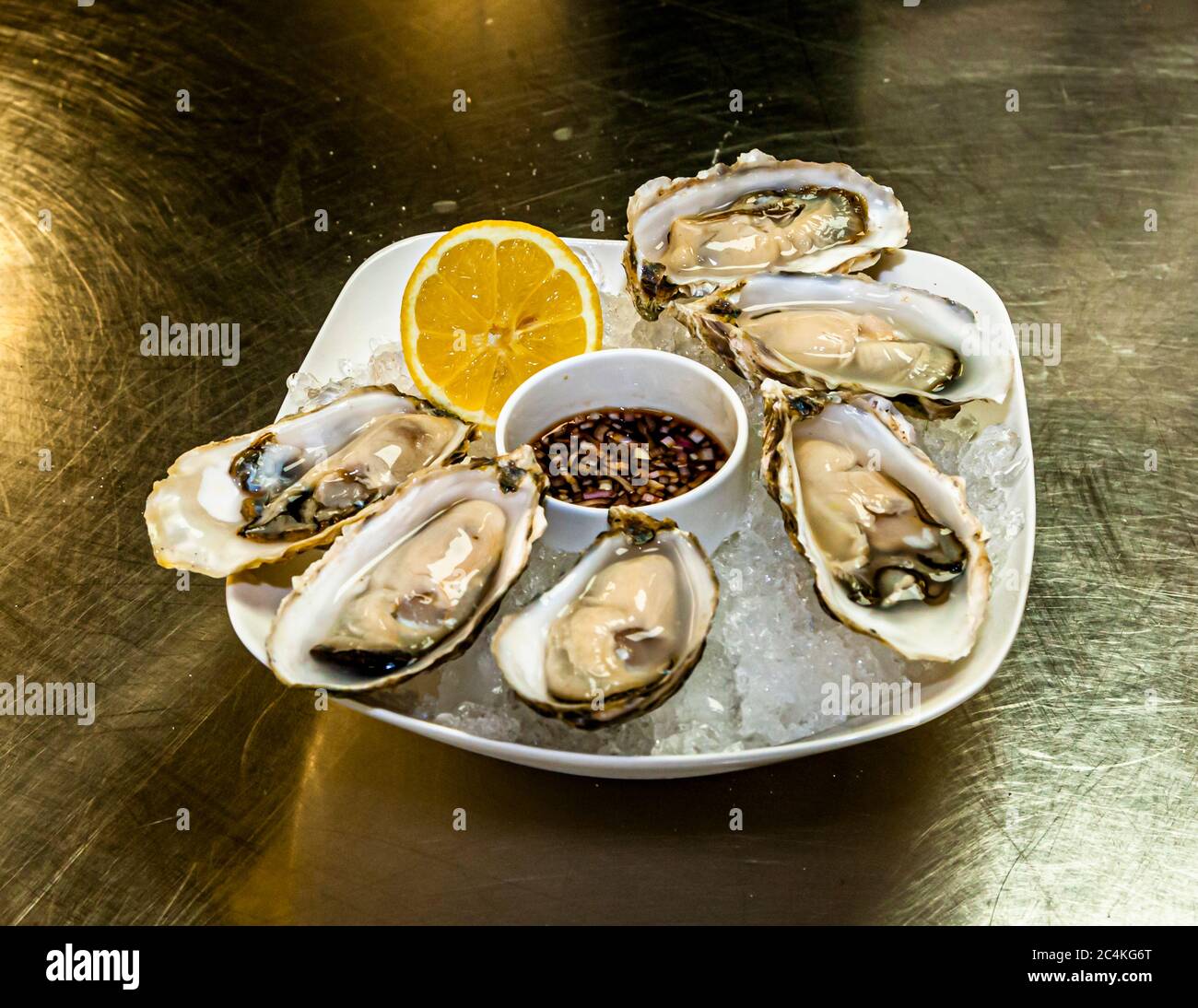 Gourmet Dish: Oysters Opening and arranging an oyster plate Stock Photo ...