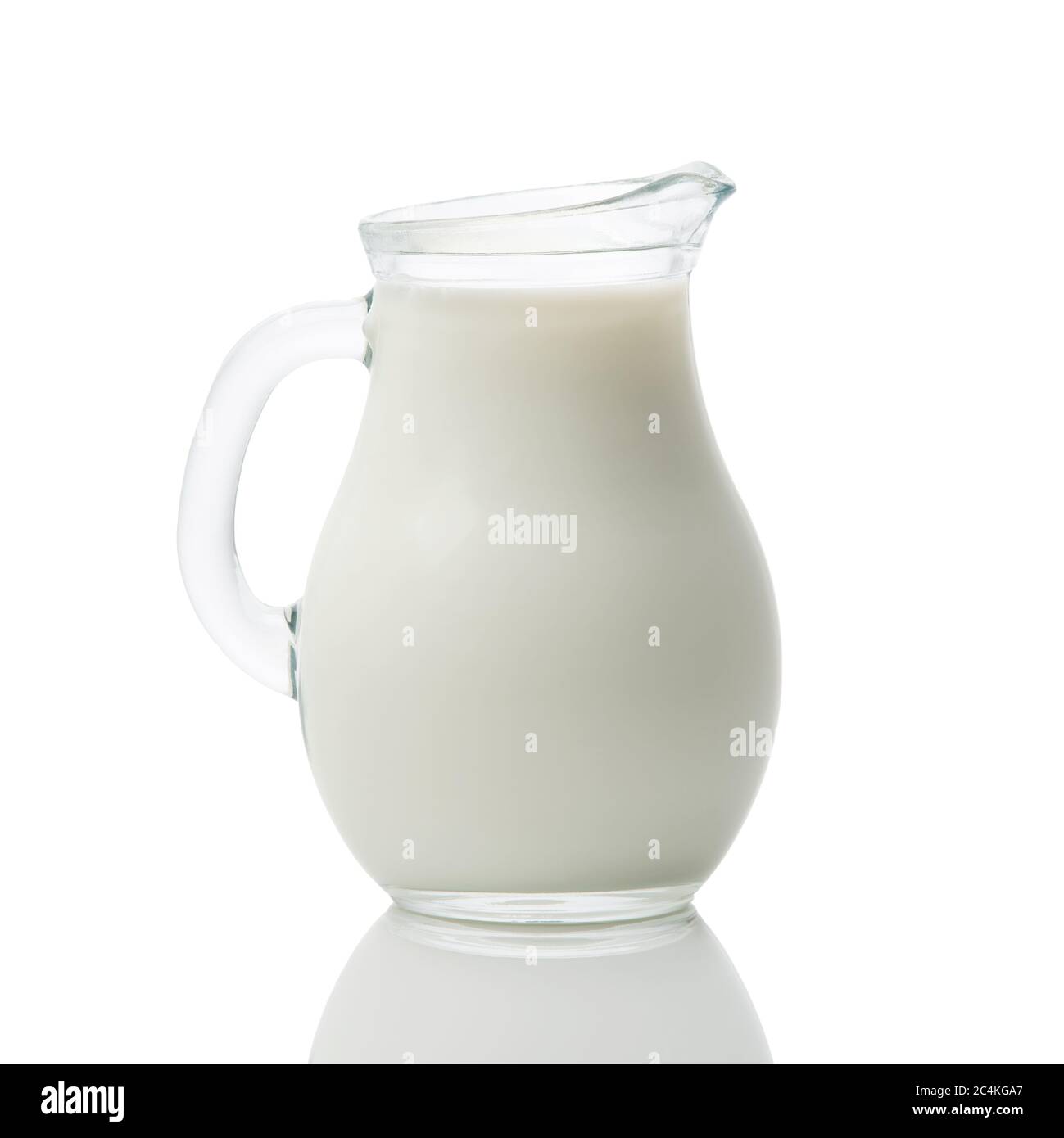 Transparent glass jug of fresh skimmed milk isolated on white ...