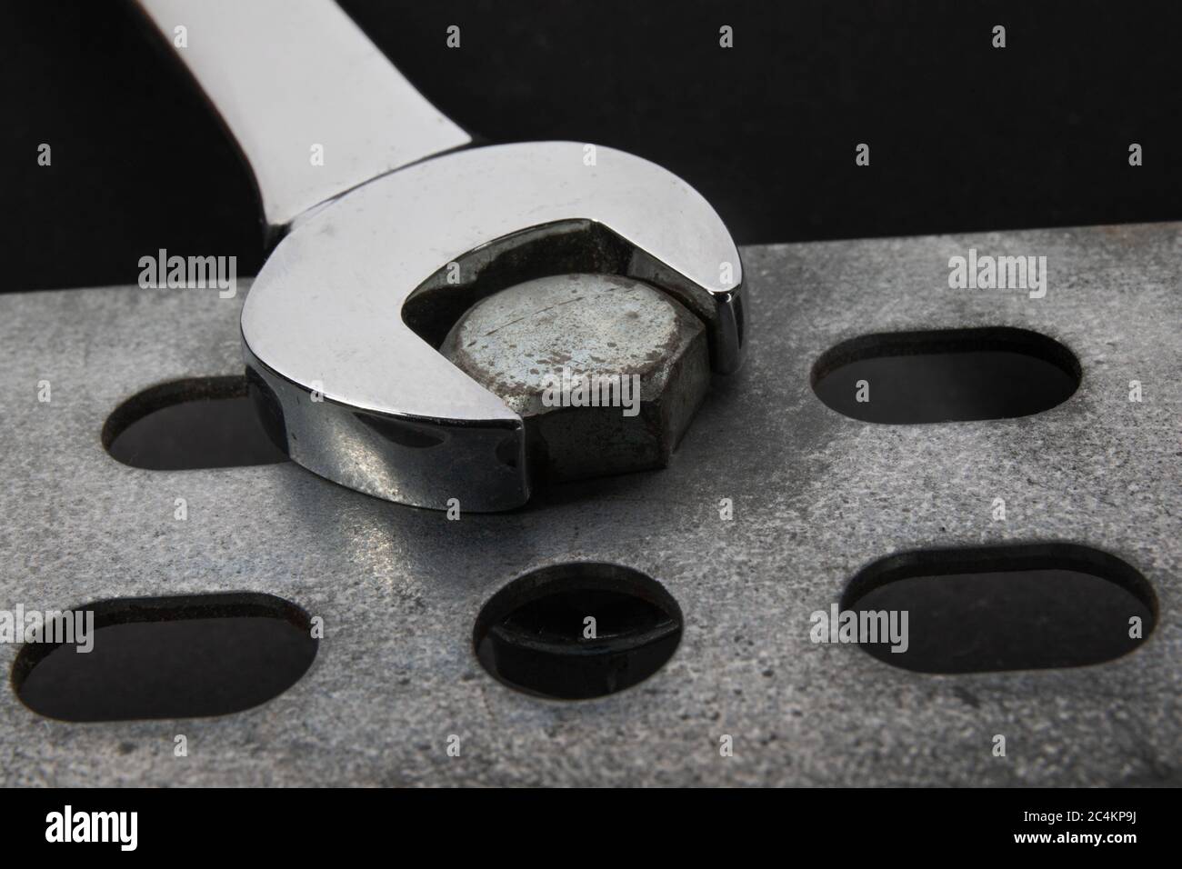 the open end of a combination box and open end wrench on a bolt head on ...