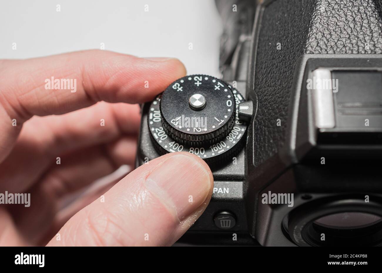 Photograph fingers changing controls and dials on a digital camera ...
