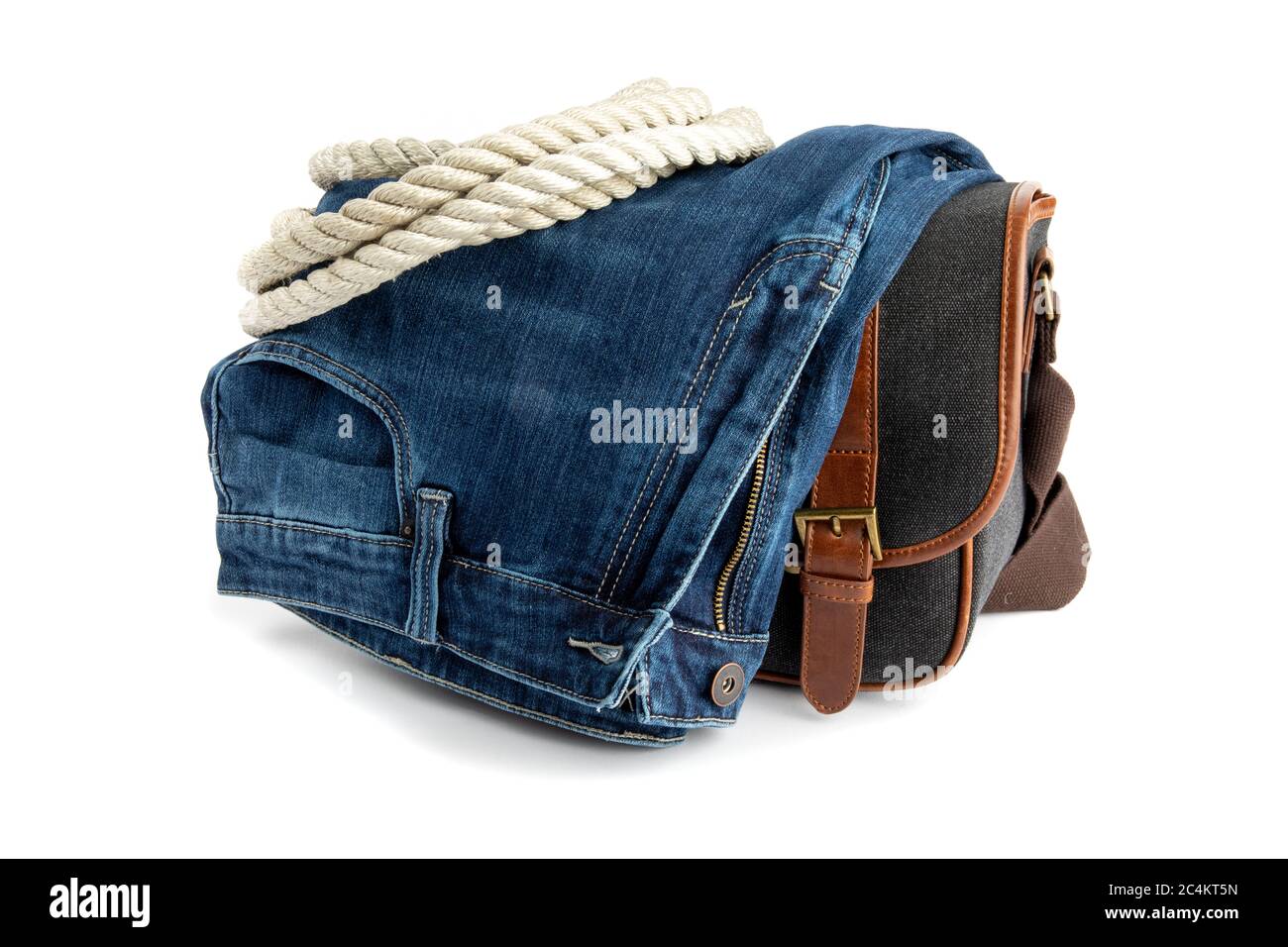 a heavy rope for climbing and a pair of folded blue denim jeans ...