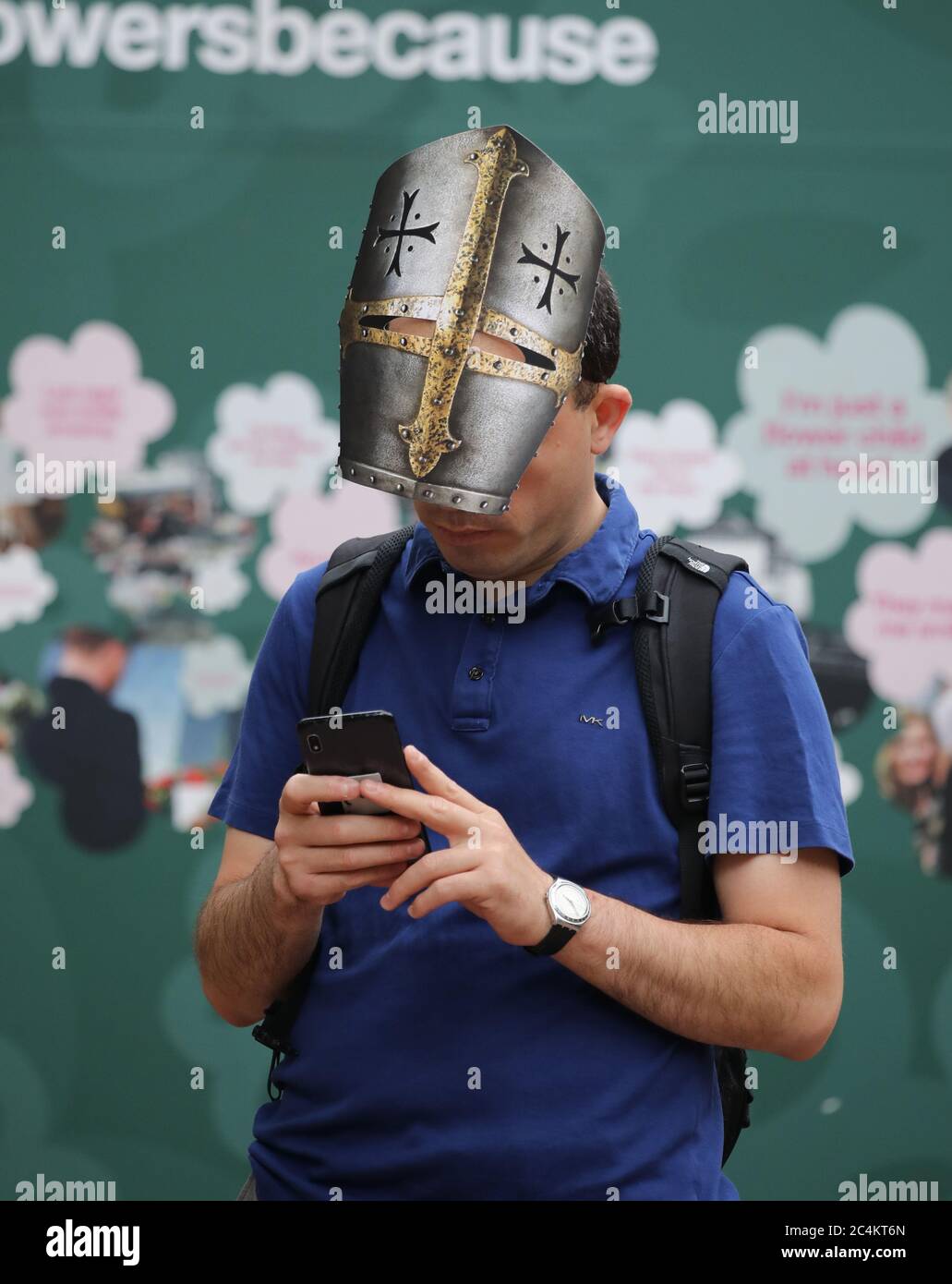 London, UK. 27th June, 2020. A person wearing a medieval mask whilst ...