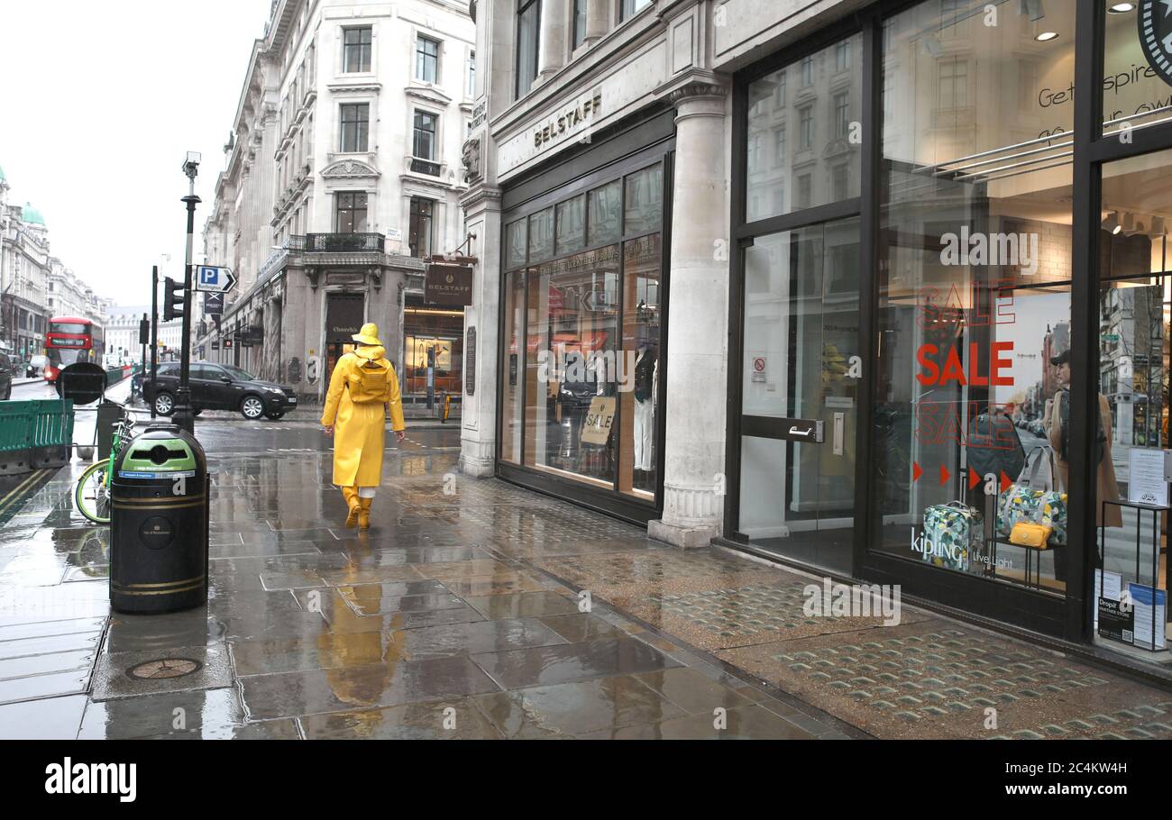 London, UK. 27th June, 2020. A man in a natty yellow rain suit during a ...