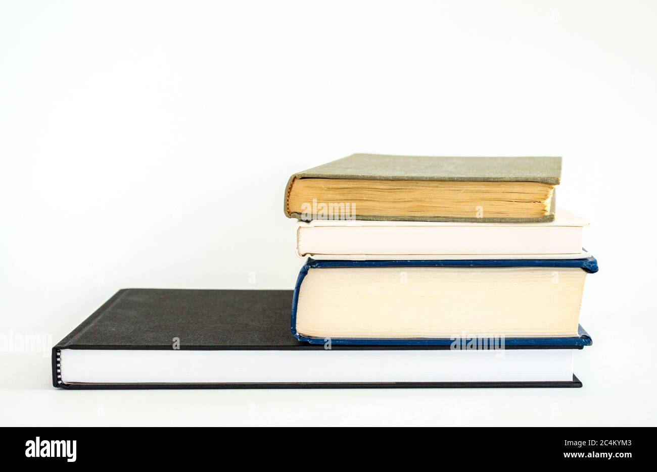 a stack of 4 books viewed from above isolated on white Stock Photo - Alamy