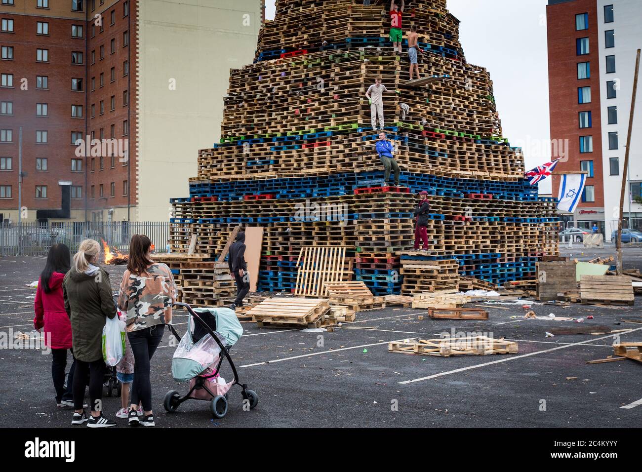 A man standing on top of a bonfire in Sandy Row, Belfast, Northern ...