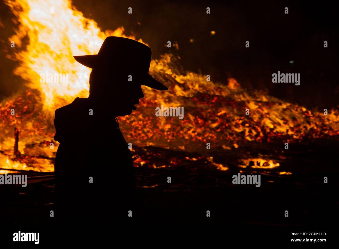 guy silhouette against a bonfire 11th night, Sandy Row, Belfast Stock ...