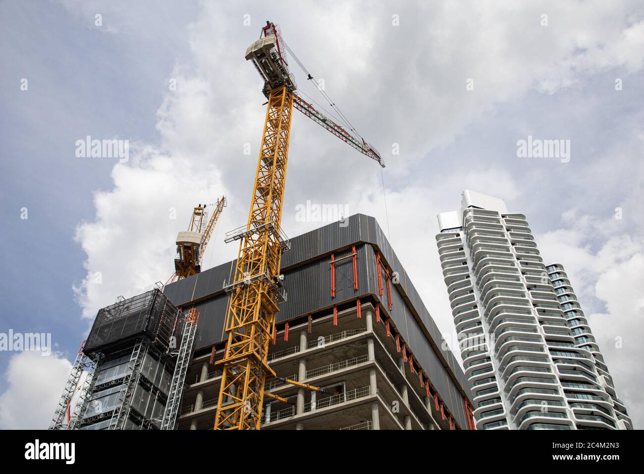 High-rise construction site with cranes and apartment building Stock ...
