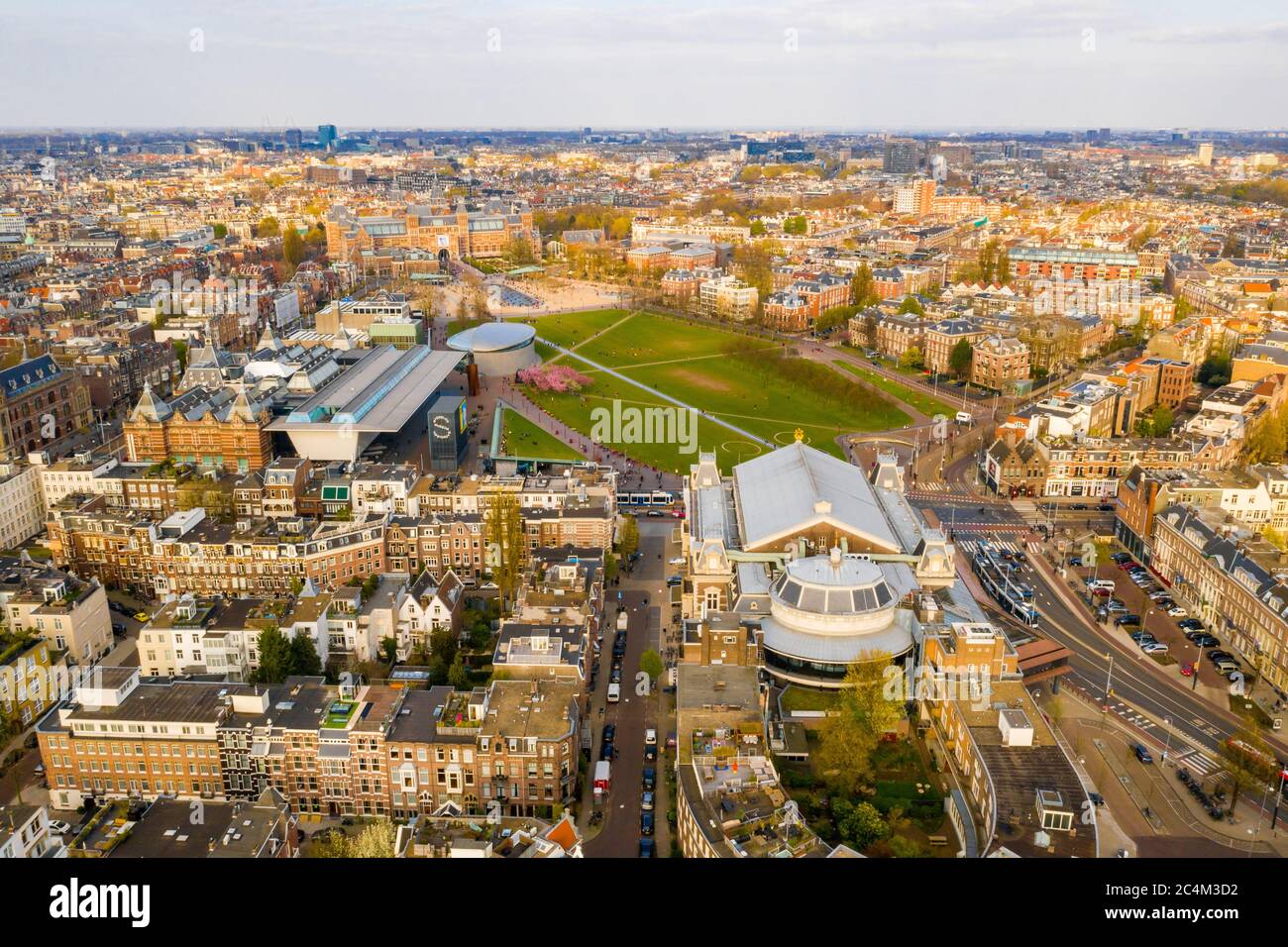 Beautiful aerial view of Amsterdam, the Netherlands with a green field ...
