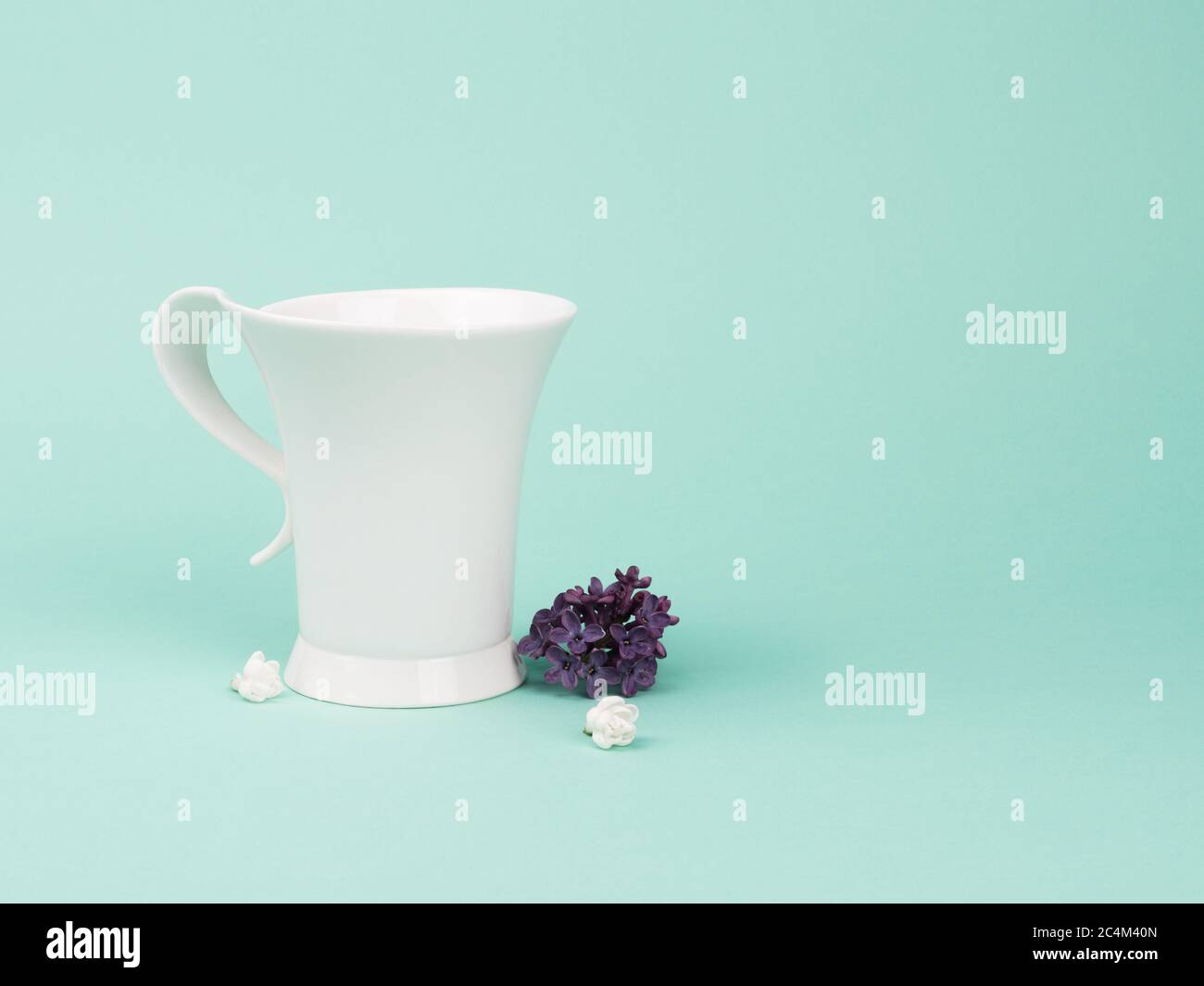 Fragile still life with lilacs and white Cup Stock Photo - Alamy