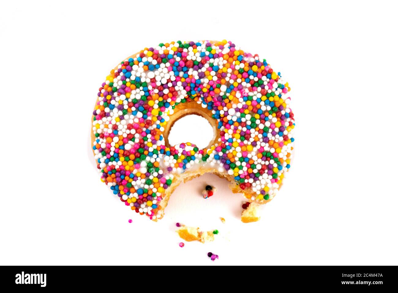 top down view of a doughnut with sprinkles with one bite taken out of ...