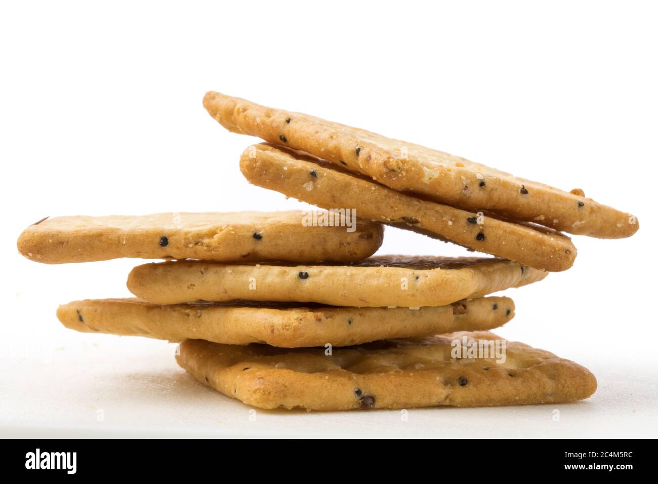 extreme closeup of a stack of multigrain crackers isolated on white ...