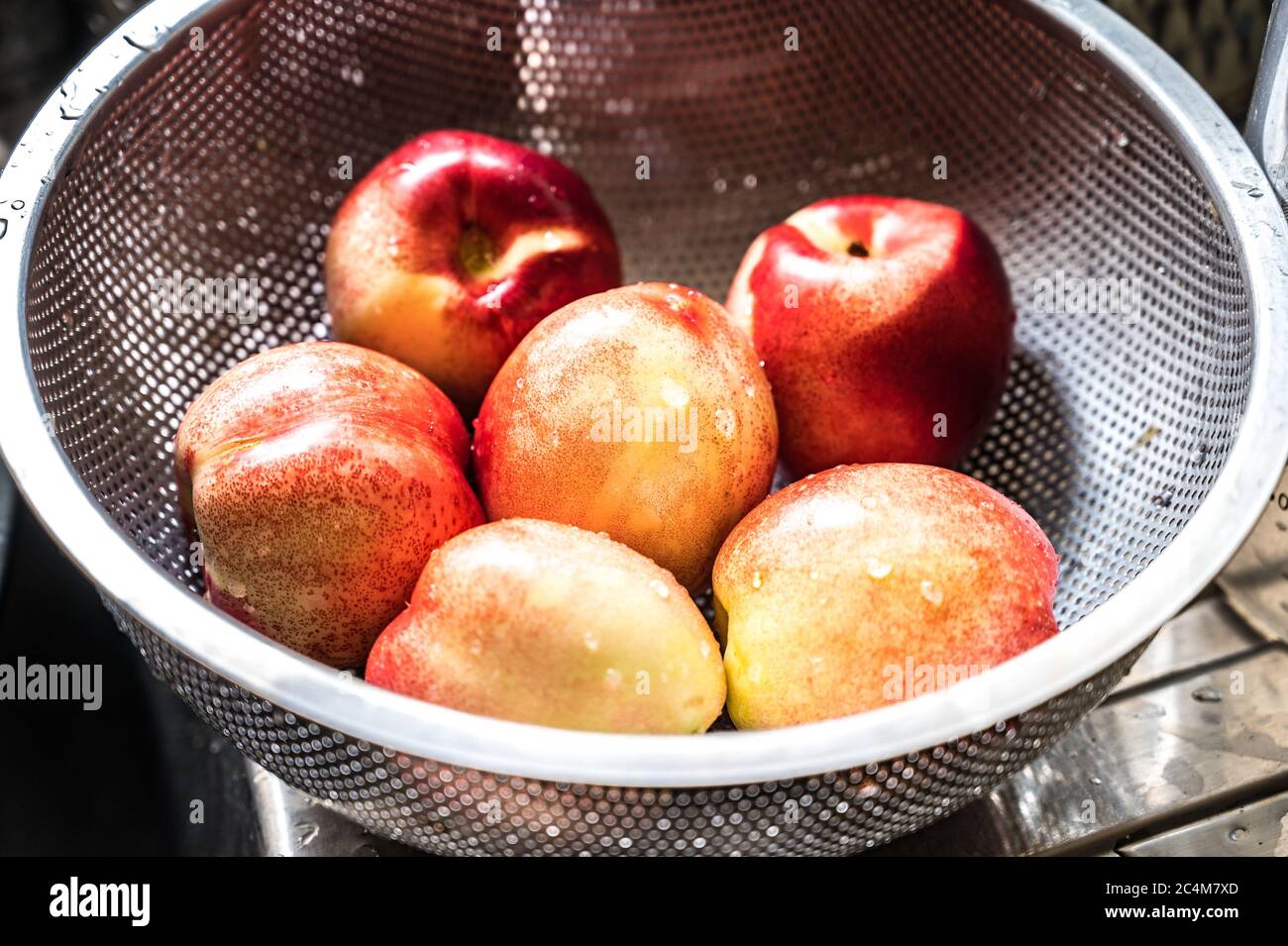Fresh and wet peaches in the strainer - perfect for background Stock ...