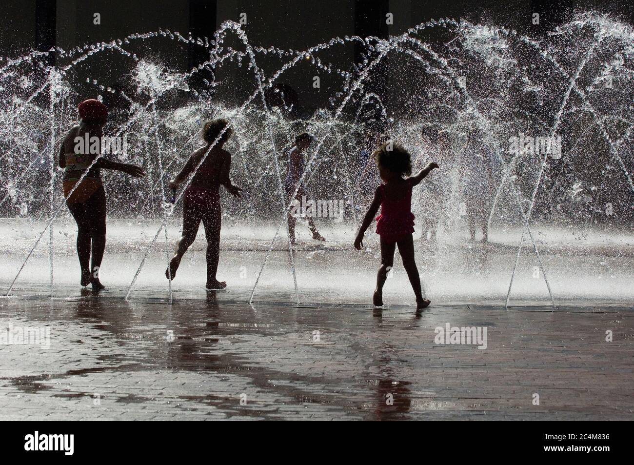 Children playing in water fountain during summer heat Stock Photo - Alamy