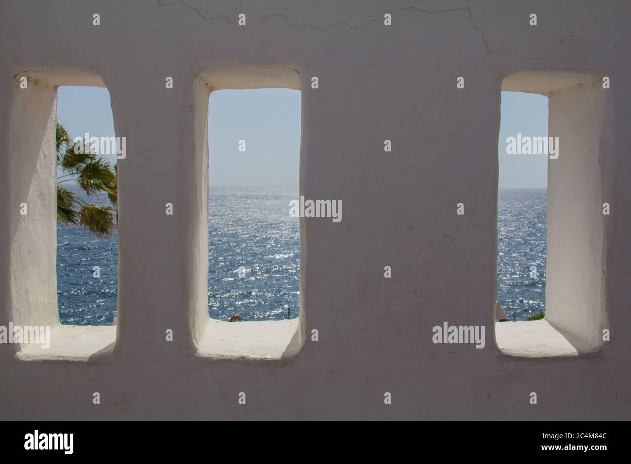 Magnificent view of the blue ocean through the windows of an old castle ...