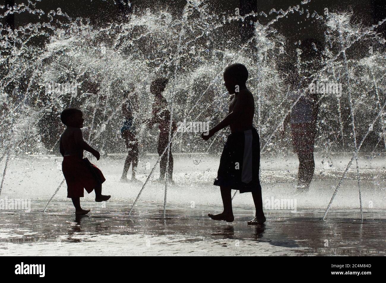 Children playing in water fountain during summer heat Stock Photo - Alamy