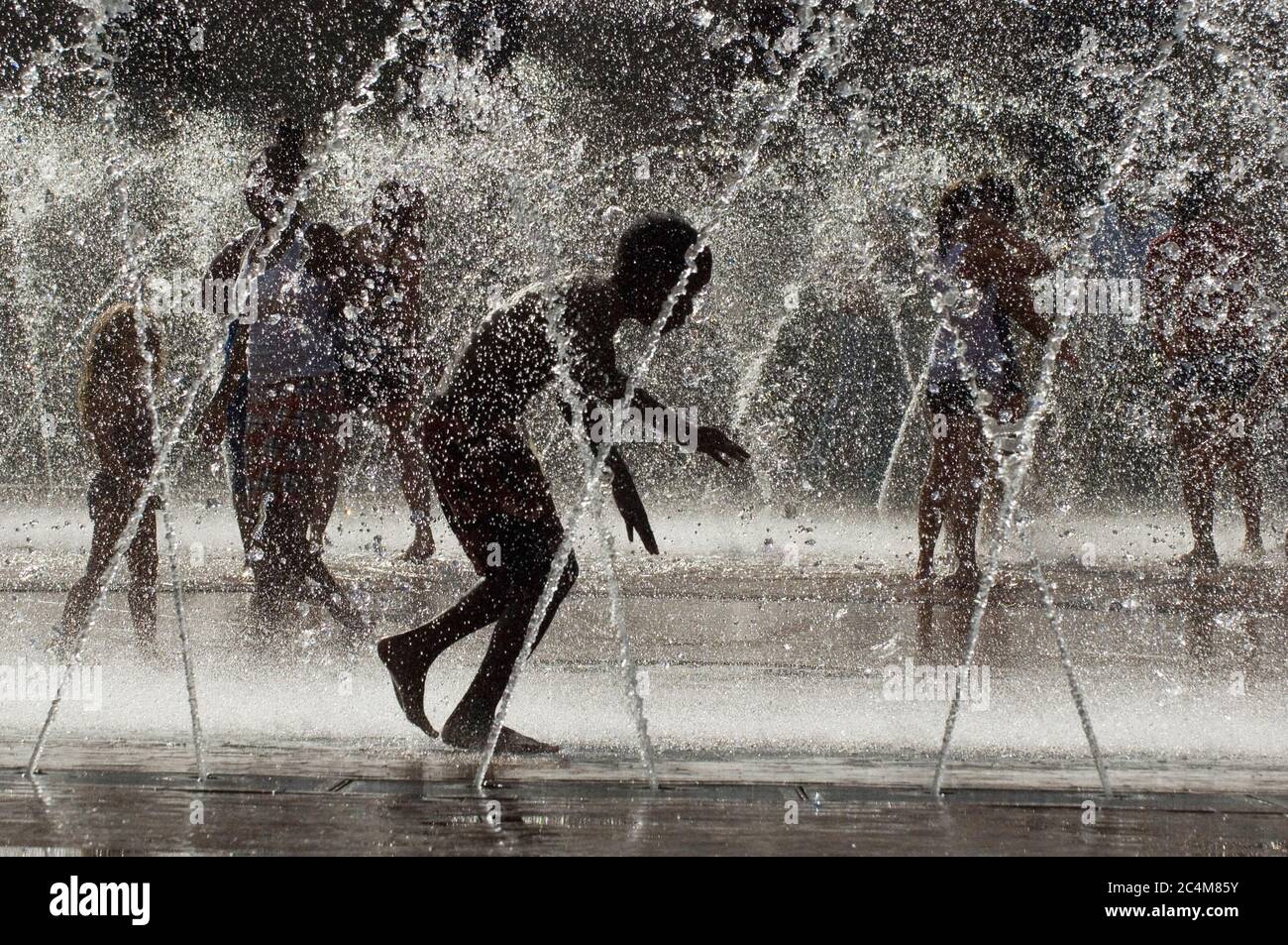 Children playing in water fountain during summer heat Stock Photo - Alamy