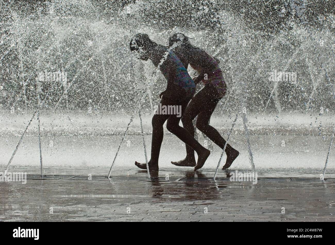 Children playing in water fountain during summer heat Stock Photo - Alamy
