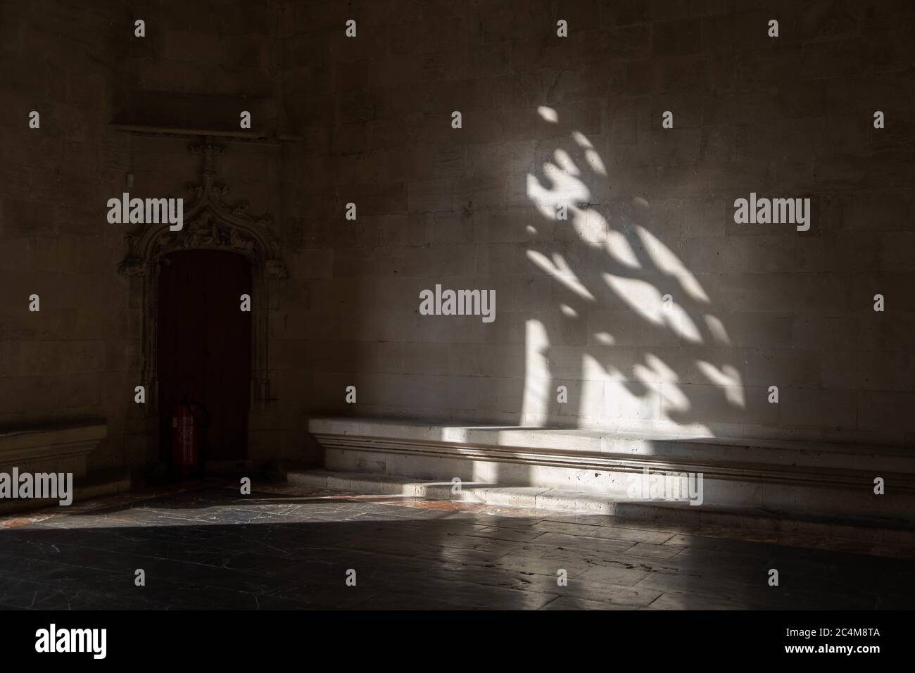 Sun shining through the windows inside a beautiful and old castle with ...
