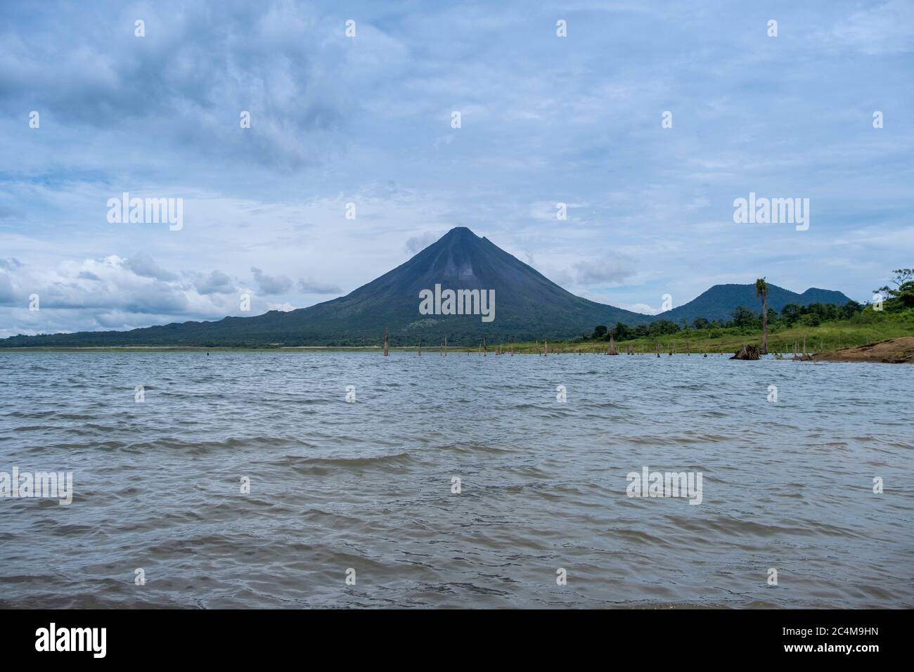 Breathtaking view of the lake and volcano captured in Arenal Volcano ...