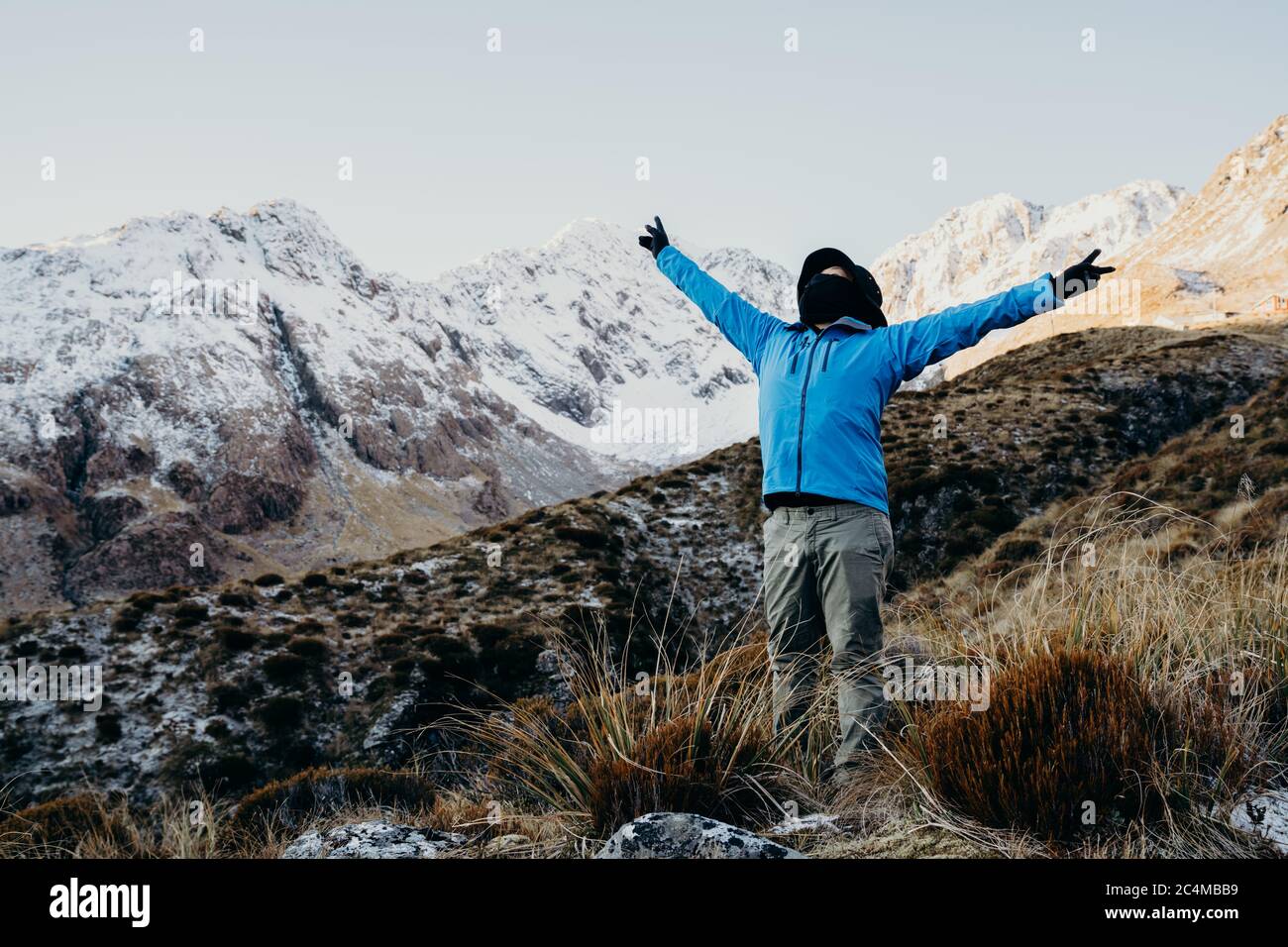 Man trekking in mountains. Cold weather, snow on hills. Winter hiking ...