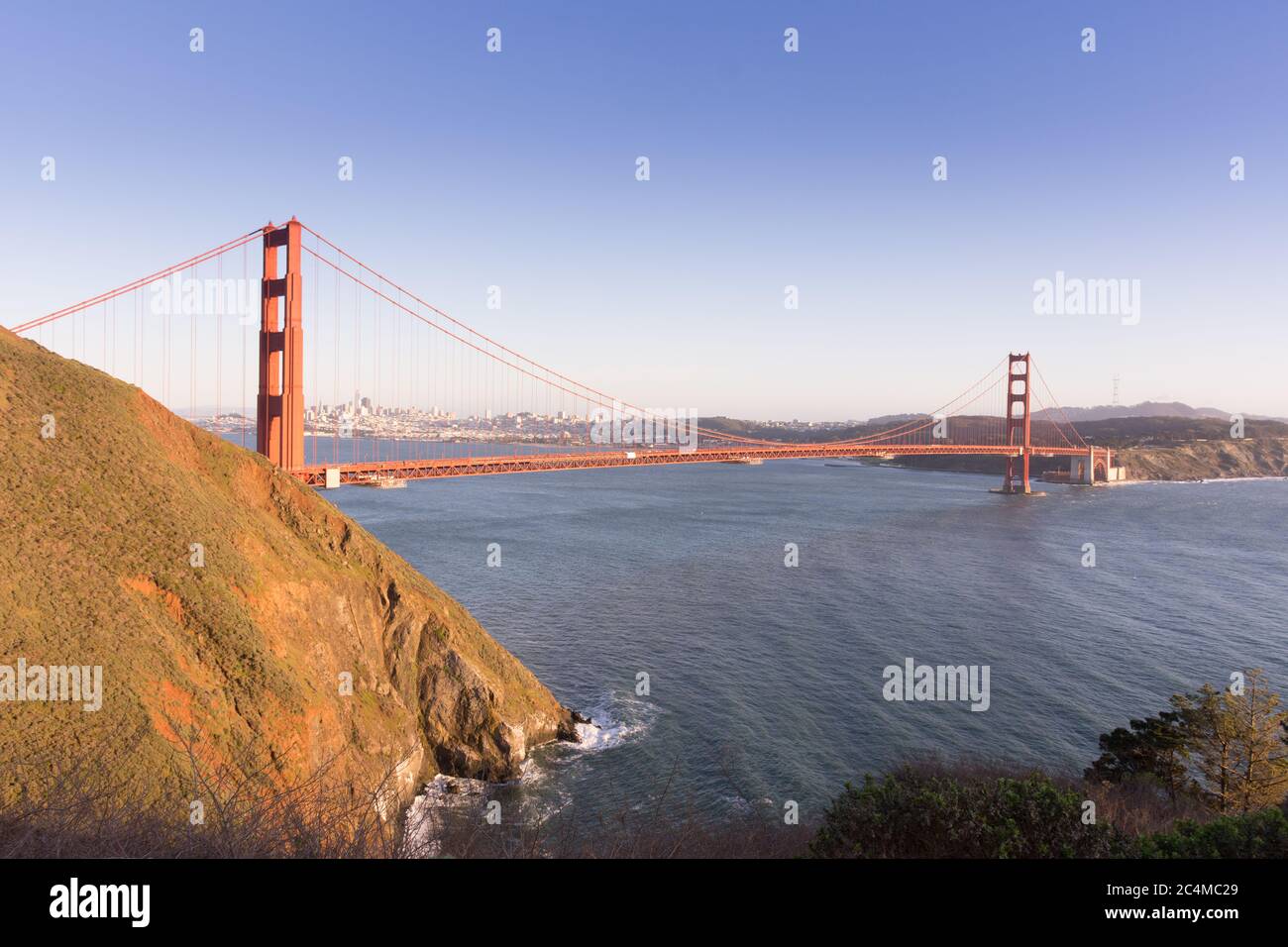 Golden Gate Bridge at sunset looking out towards the city of San ...