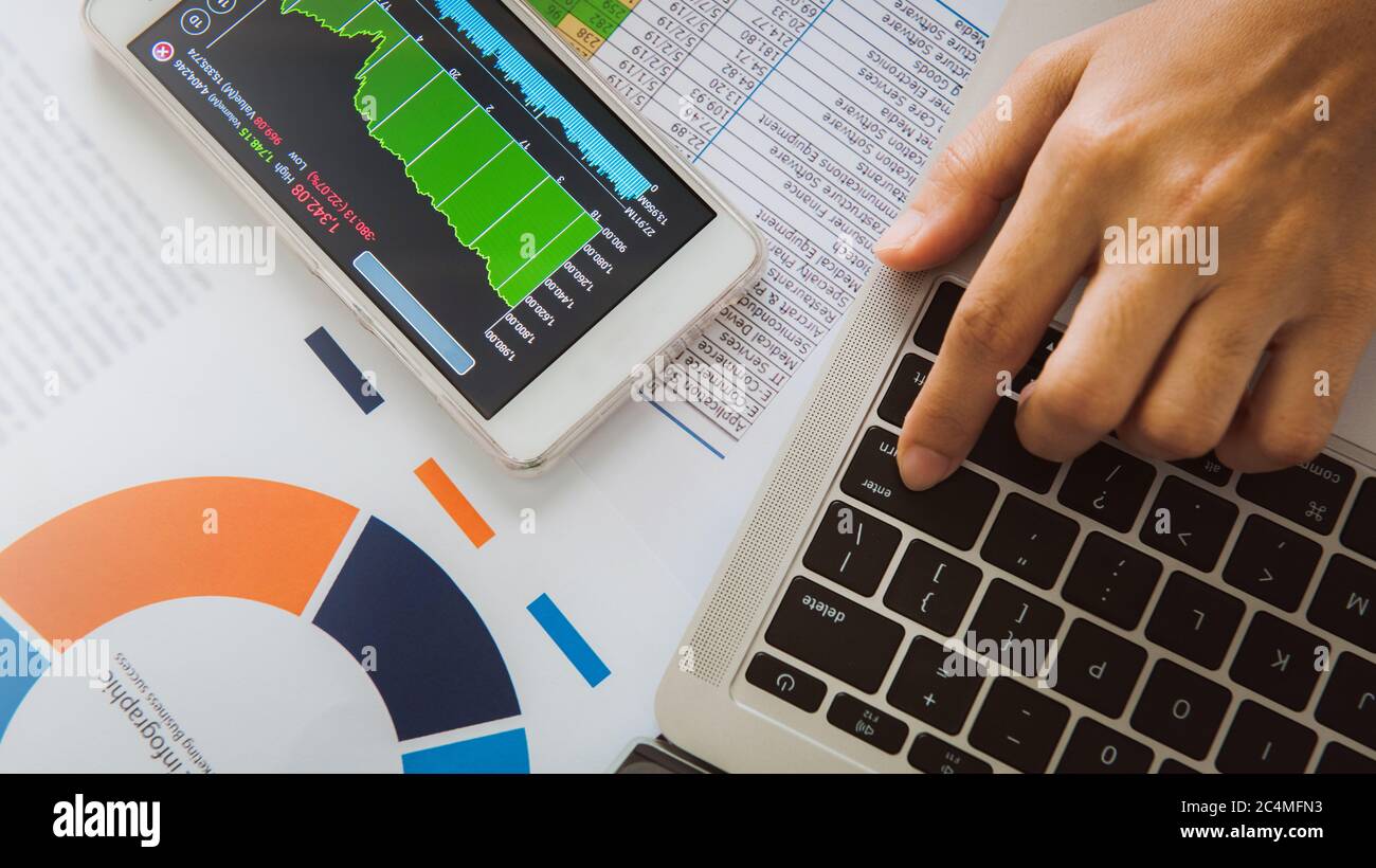 Businesswoman analyze business report graph and finance chart using ...