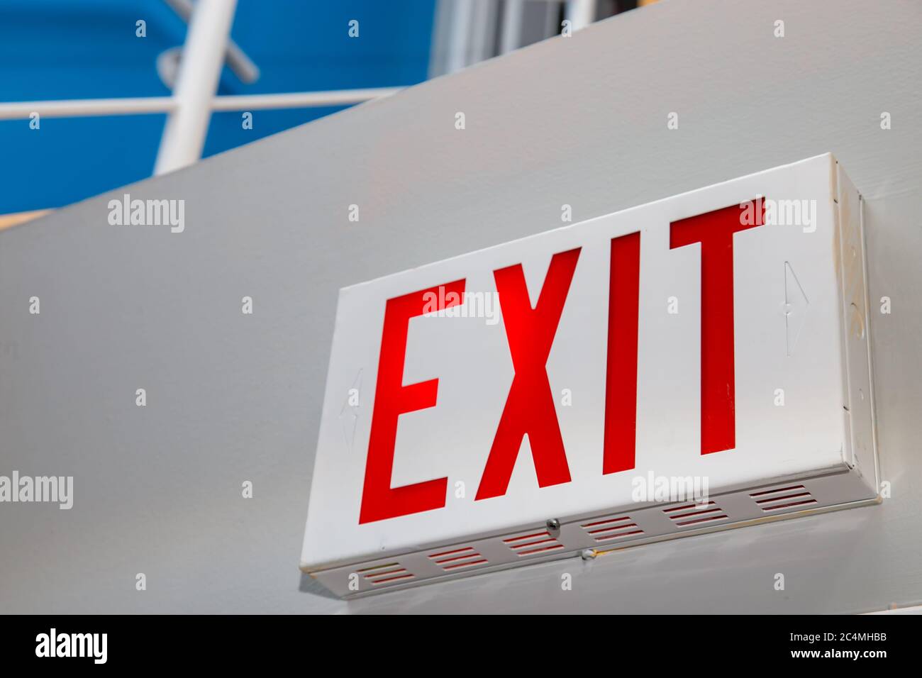 A perspective view from a low angle showing a red "EXIT" sign on a ...