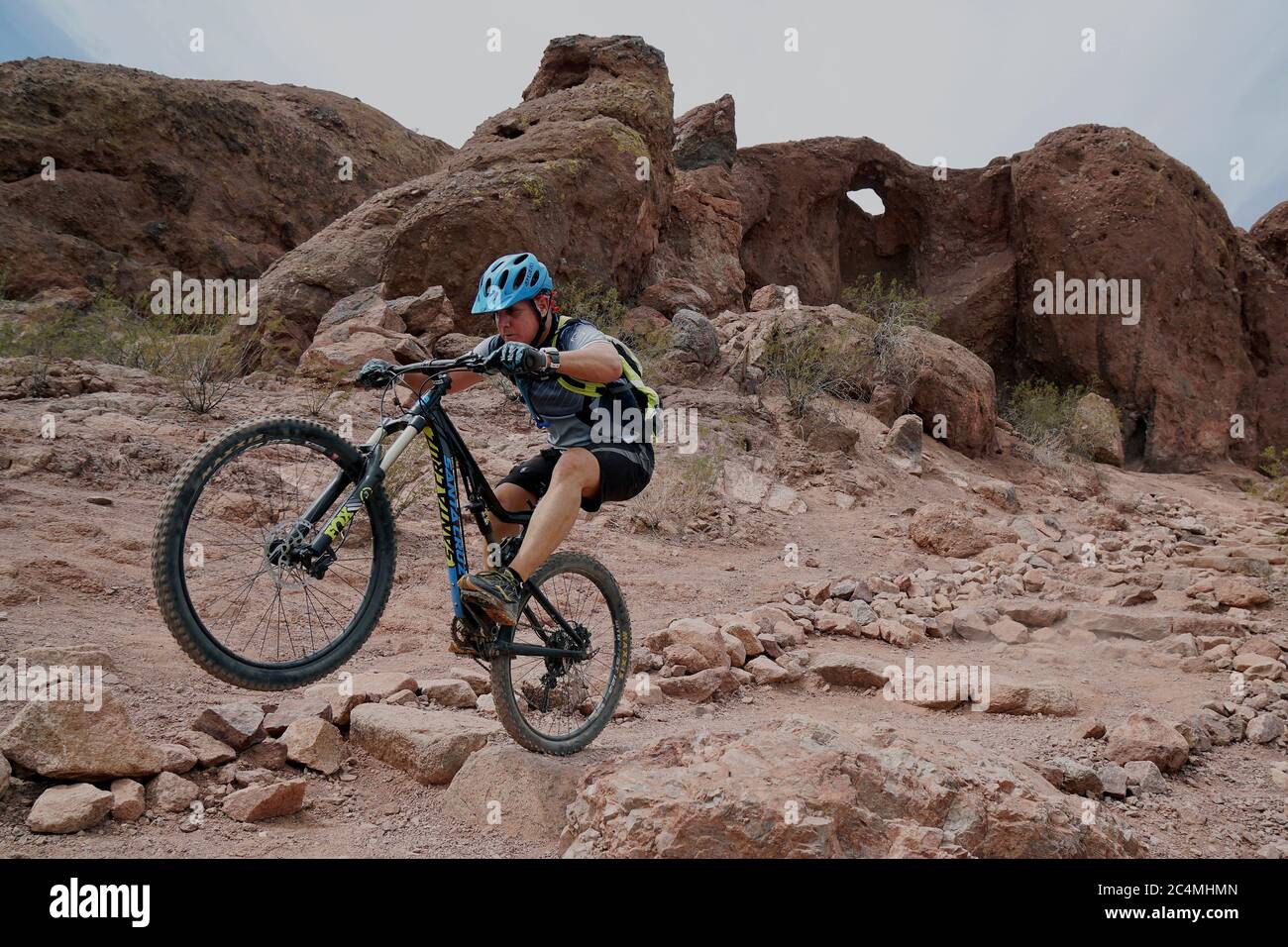 A mountain biker rides through the tough terrain in the Arizona desert ...