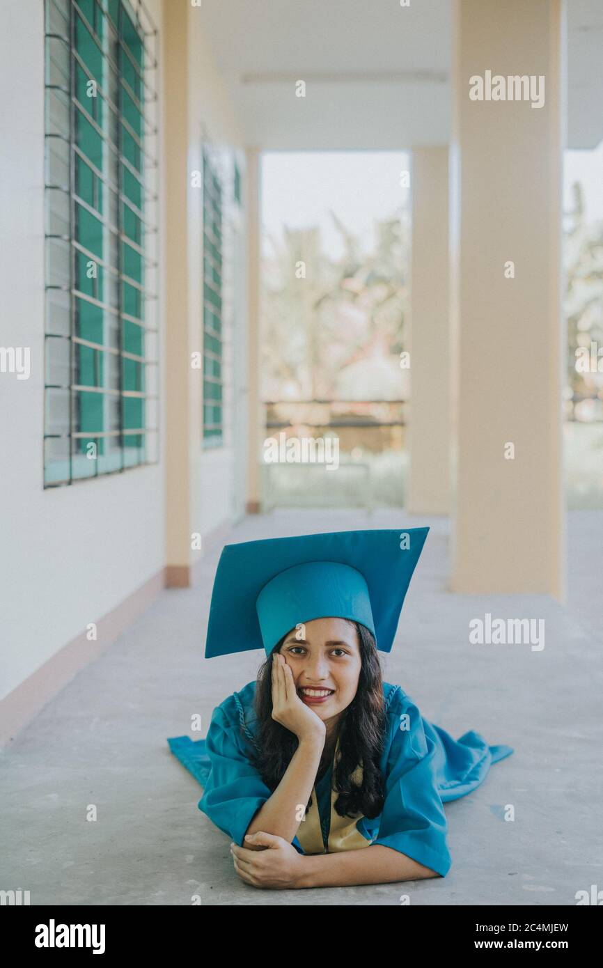Portrait of a Filipino Woman wearing her Graduation cap, gown and Sash ...