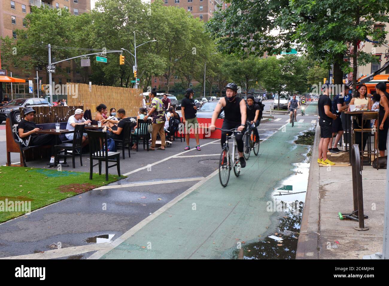 New York, NY. June 27, 2020. People in a detached dining parklet ...
