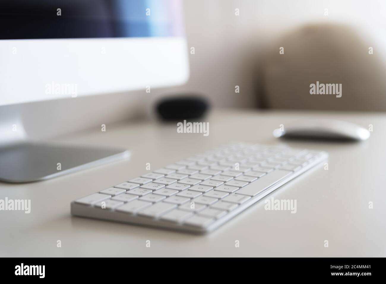 Work desk with a computer on a blurred background Stock Photo - Alamy