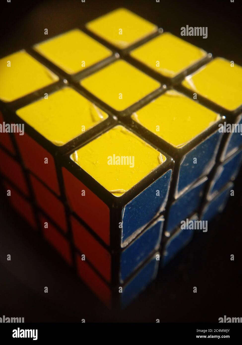 Vertical shot of Rubik's cube isolated on a black background Stock Photo - Alamy